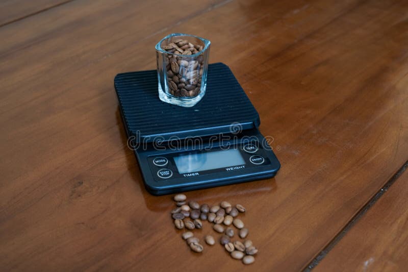 Coffee Bean Inside the Glass on a Digital Coffee Scale and Scattered ...