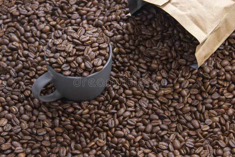 Coffee Beans in Dark Cup on Mixed Coffee Beans Background Stock Image ...