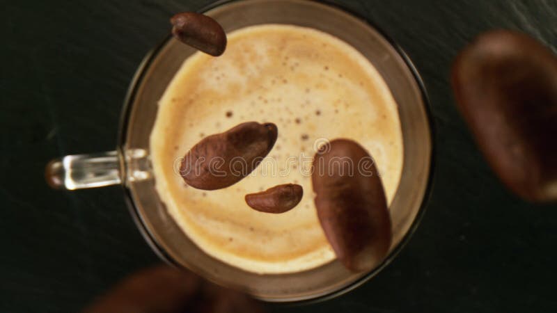 Coffee Beans Falling into Cup of Coffee Stock Photo - Image of organic ...