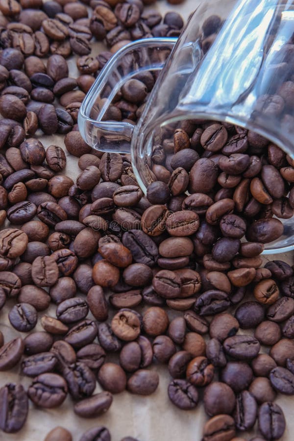 Coffee Beans in a Glass Cup on Brown Paper Background Stock Image ...