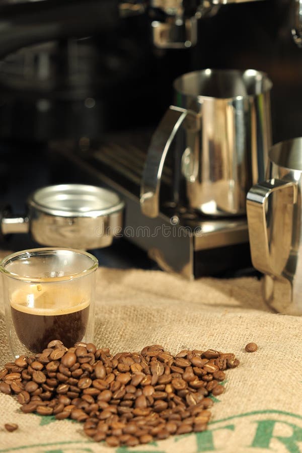 Coffee Beans and Glass Mug in Front of a Coffee Machine Stock Photo ...