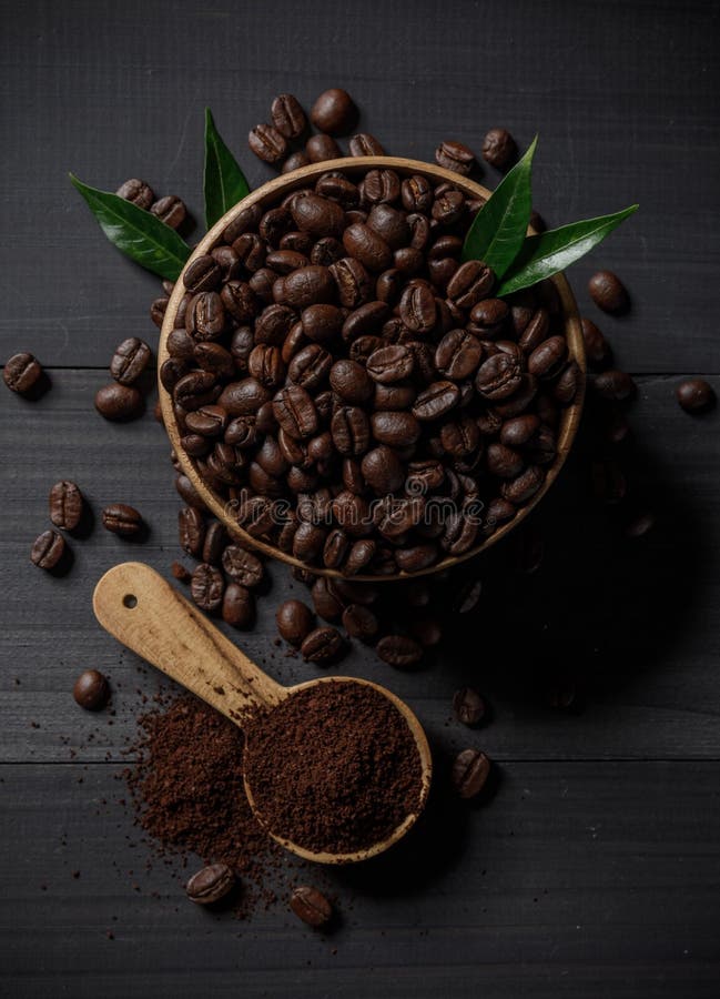Coffee Beans and the Ground Powder of Coffee on the Wooden Table Stock ...