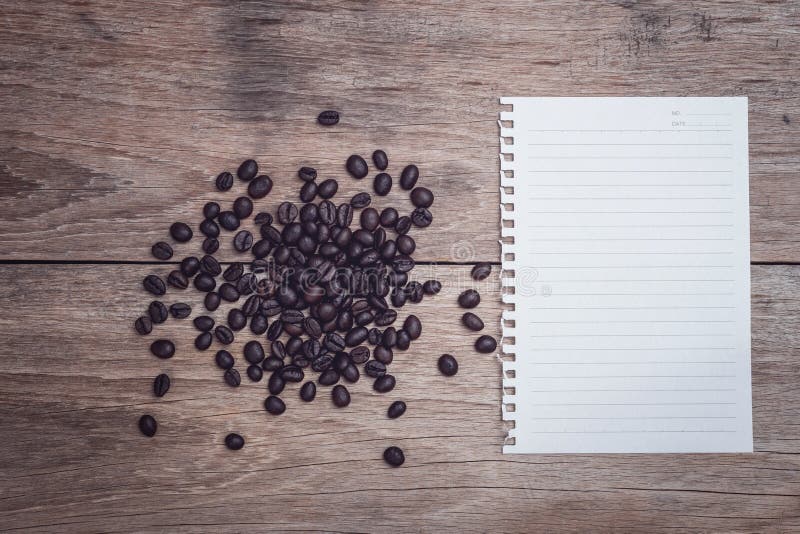 Coffee Beans and and Lined Paper on Wooden Table Top View Stock Image ...