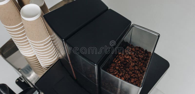 Coffee Beans in Coffee Machine and Stack of Coffee Cups Stock Image ...