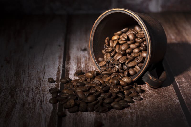 Coffee Beans Spilled Out of the Cup on the Table Stock Photo - Image of ...