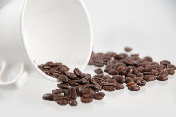 Coffee Beans Spilling Out of a Mug Stock Photo - Image of saucer, fresh ...