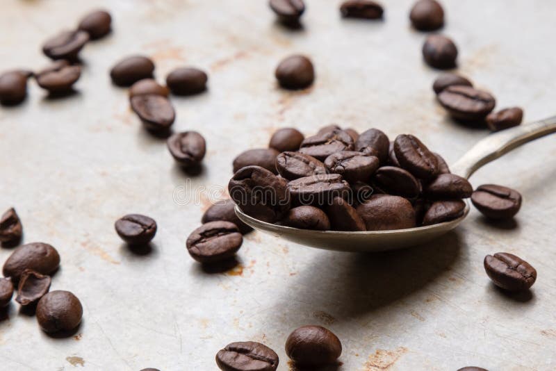 Coffee beans on spoon stock image. Image of closeup, plate - 73459387