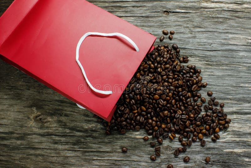 Coffee Beans Were Scattered from the Red Packing on a Wooden Table ...