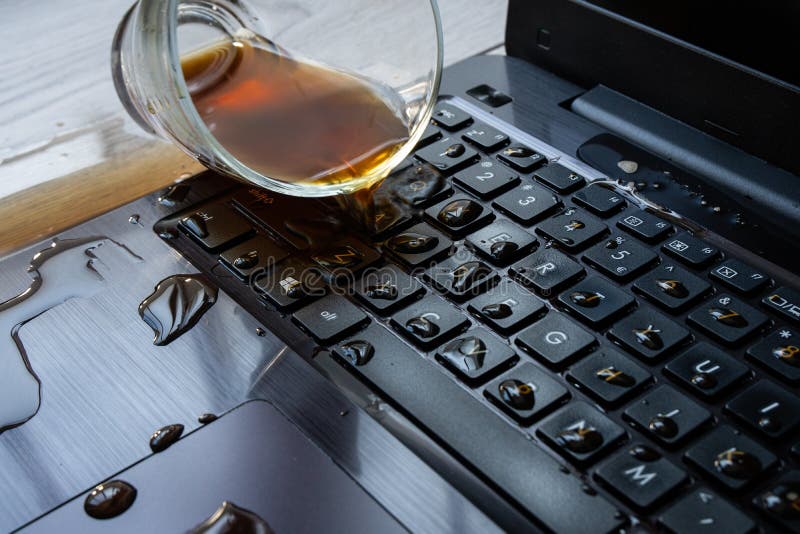 Coffee Being Spilled Over Laptop by Accident. Keyboard is Full of ...