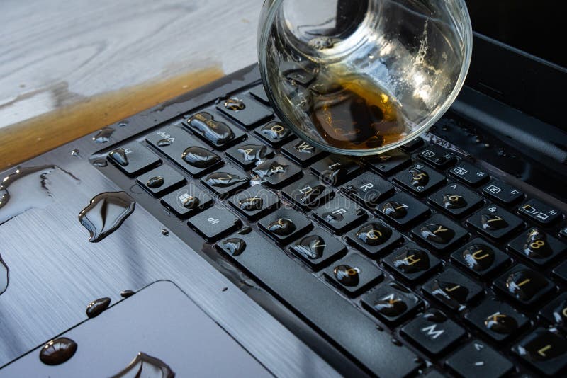Coffee Being Spilled Over Laptop by Accident. Stock Image - Image of ...