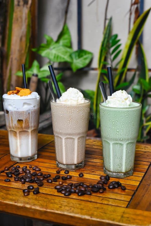 Coffee Beverages with Coffee Beans on Wooden Table in a Coffee Shop ...