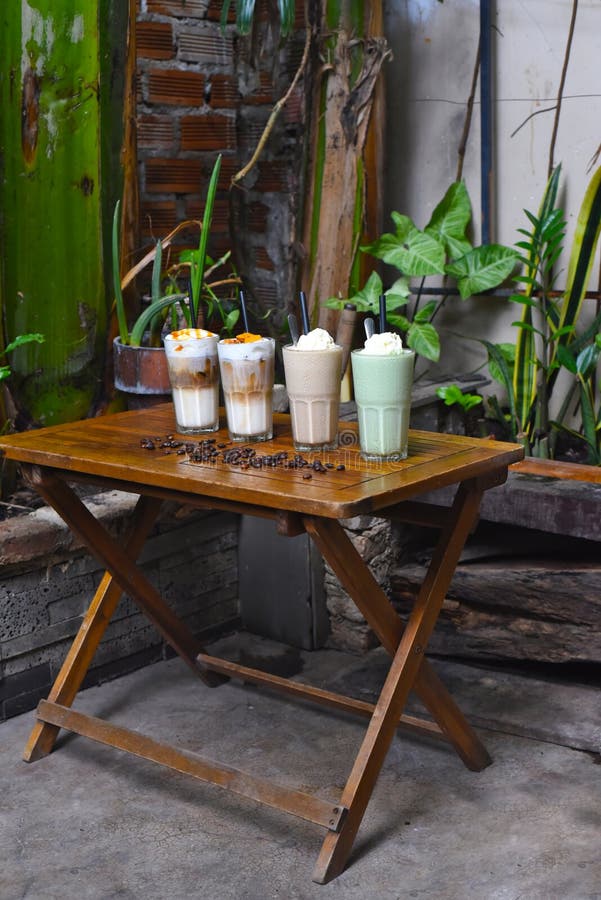 Coffee Beverages on Wooden Table in a Coffee Shop Stock Photo - Image ...