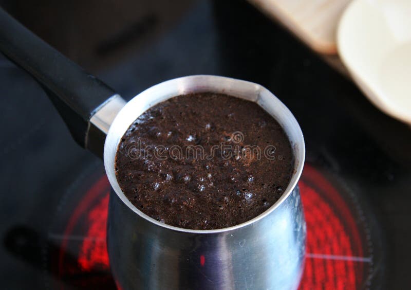 Coffee boiling in a jezve stock image. Image of brewing - 71048255