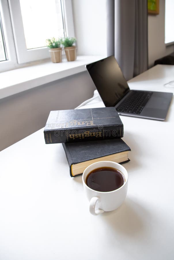 Coffee, Books and a Laptop on a Light Table by the Window Stock Photo ...