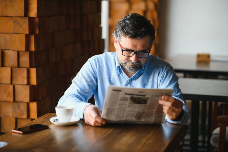 Coffee Break. Man Drinking Coffee and Reading Newspaper in Cafe Bar ...
