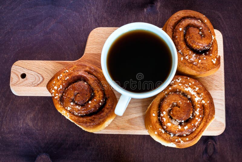 Coffee with cinnamon rolls stock image. Image of board - 101334301