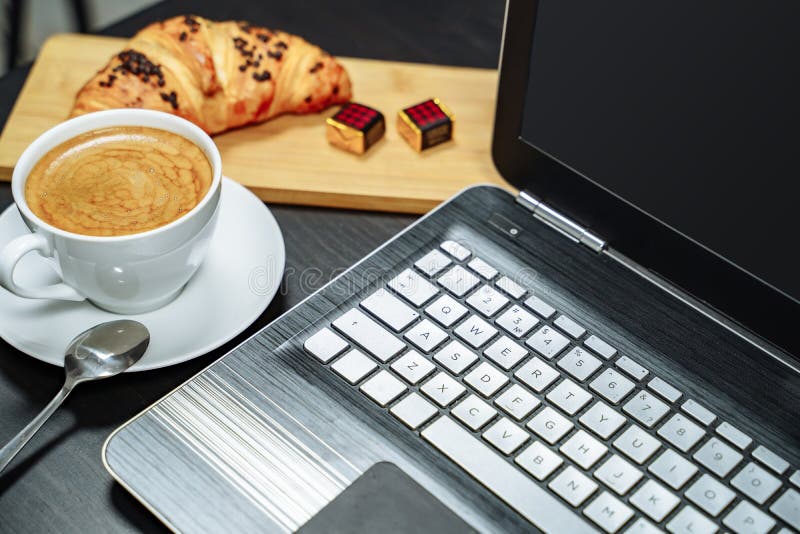 Coffee, Croissant and Laptop on the Table. Breakfast Stock Image ...