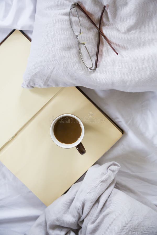 Coffee Cup, Book, Reading Glasses on Bed Stock Photo - Image of coffee ...