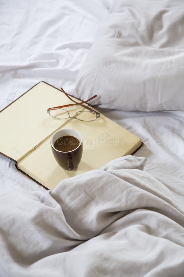Coffee Cup, Book, Reading Glasses on Bed Stock Photo - Image of ...