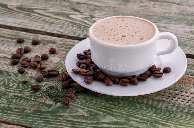 Coffee Cup with Foam and Beans on Wood Table Stock Photo - Image of ...