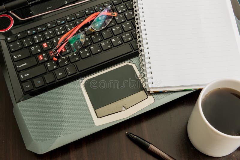 Coffee Cup, Laptop, Pen , Notepad and Glasses on Wooden Table Stock ...