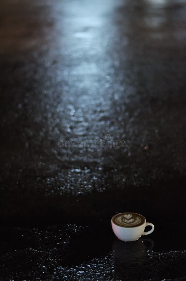 Coffee Cup with Latte Art on the Floor after Raining at Night Stock ...