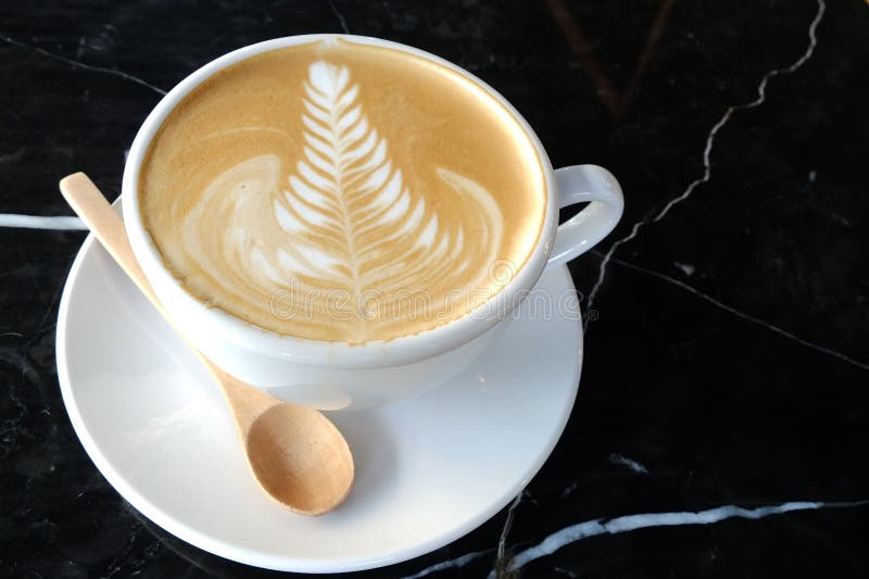 Coffee Cup with Latte Art Rosetta Pattern on the Black Marble Ta Stock ...