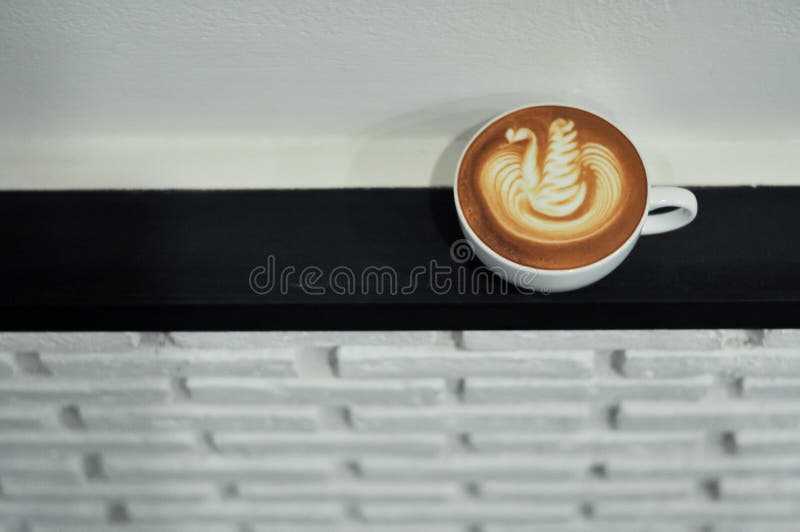 Coffee Cup with Latte Art Swan Pattern on the Wall Ridge Stock Image ...