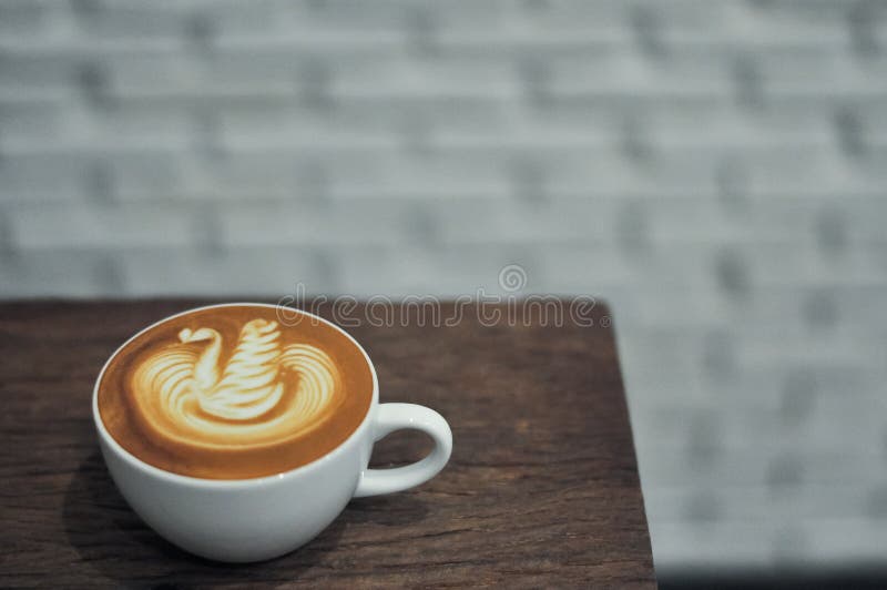 Coffee Cup with Latte Art Swan Pattern on the Wood Table Stock Photo ...