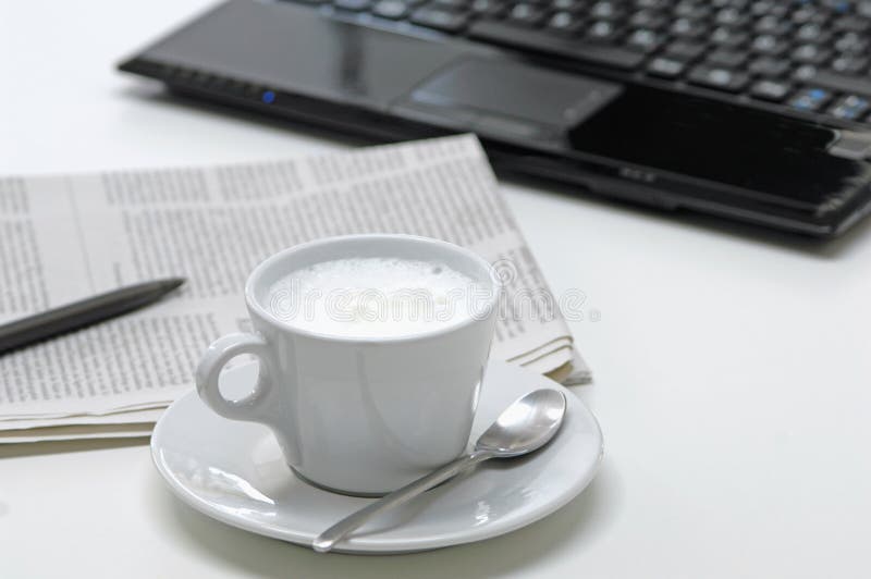 Coffee Cup with Newspaper and Laptop in Background Stock Image - Image ...