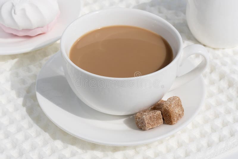 Coffee in a Cup with Sugar Cubes and a Sweet Treat on a White Surface ...