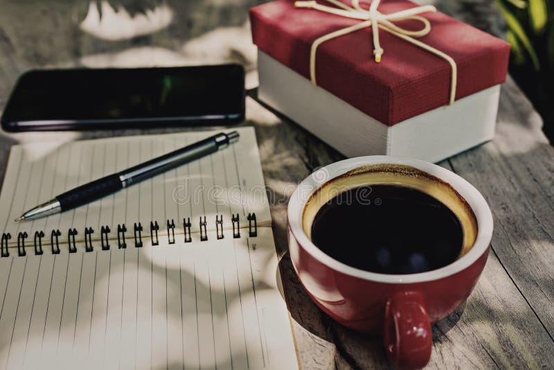 Coffee Cup on the Table Near Paper Short Note and Gift Box Stock Photo ...