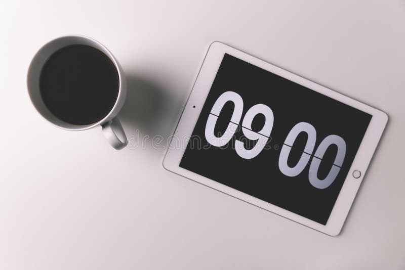 Coffee Cup with Time Display on Digital Clock on Tablet Computer Stock ...