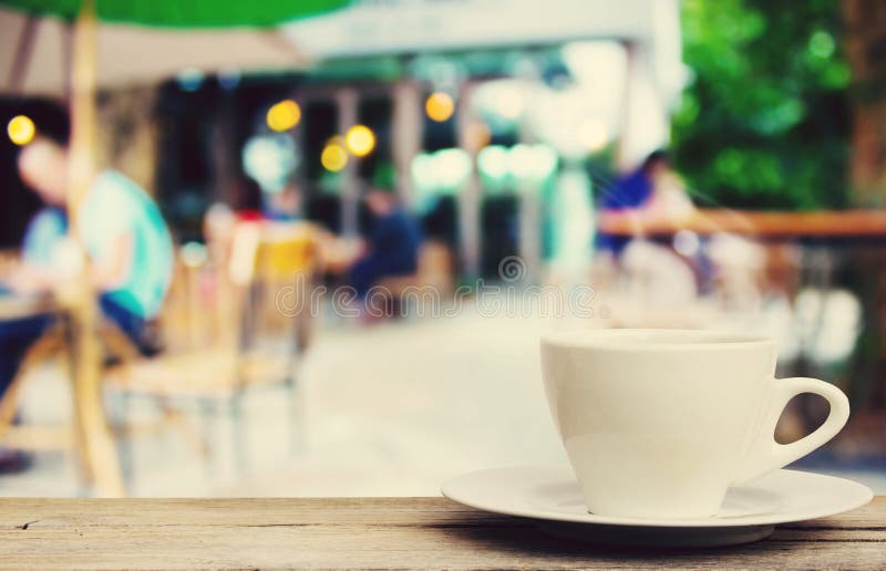 Coffee Cup on Wood Table with Blur Coffee Shop Background Stock Image ...