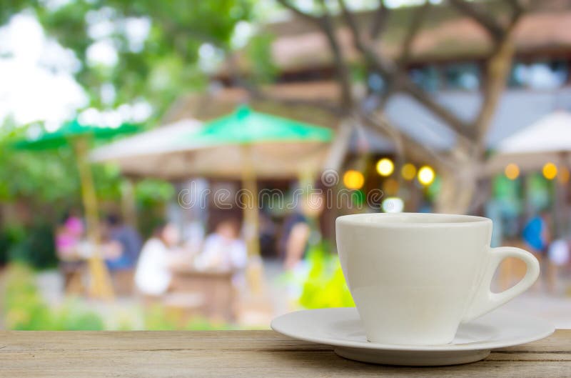 Coffee Cup on Wood Table with Blur Coffee Shop Background Stock Image ...