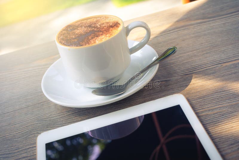 Coffee and Digital Tablet during a Sunny Morning Stock Photo - Image of ...