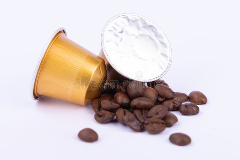 Coffee Gold: Capsules and Beans on a Clean White Surface Stock Photo ...