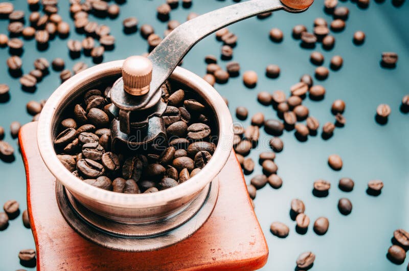 Coffee Grinder with Coffee Beans on the Reflective Surface. Making ...