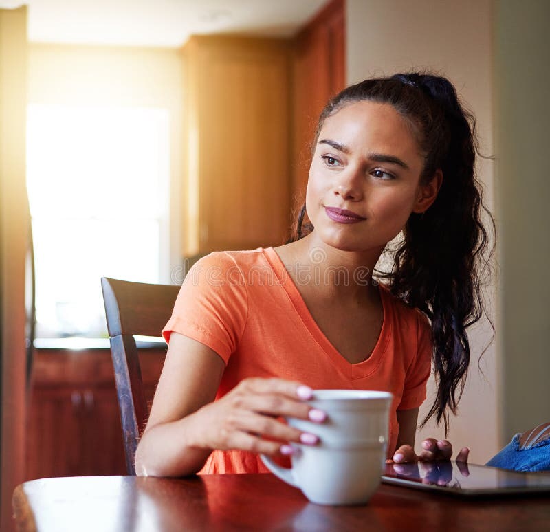 Coffee and Her Tablet Equal Relaxation. a Smiling Young Woman Sitting ...