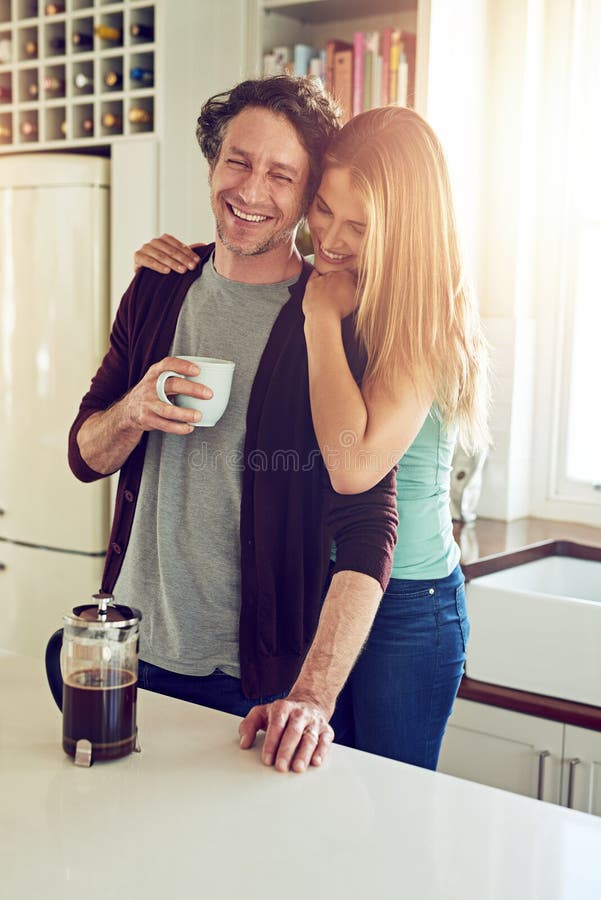 Coffee is a Hug in a Mug. an Affectionate Couple in the Kitchen. Stock ...