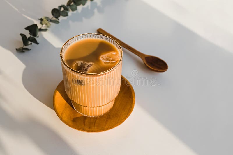 Coffee with Ice in a Crystal Glass on the White Table in Natural Light ...