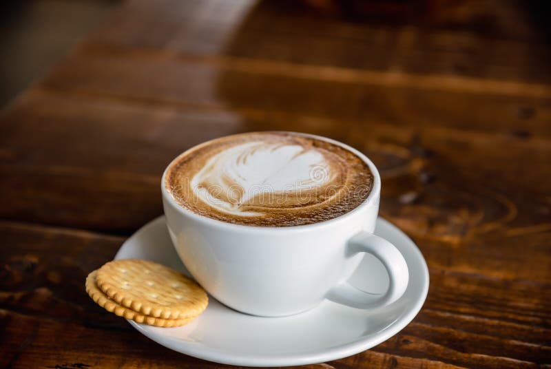 Coffee Latte Served with a Couple of Biscuit Stock Photo - Image of ...
