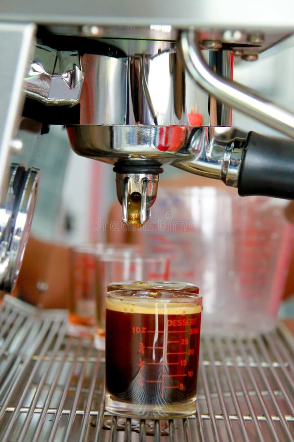 Coffee Machine Brewing a Coffee. Coffee Pouring into Shot Glasse Stock ...