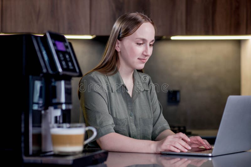 Coffee Machine Prepares Coffee while the Woman Working at the Computer ...