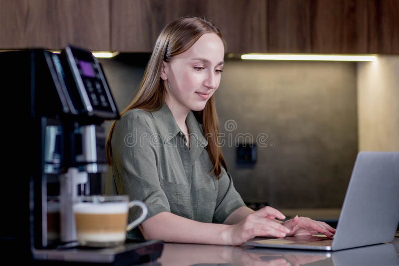 Coffee Machine Prepares Coffee while the Woman Working at the Computer ...