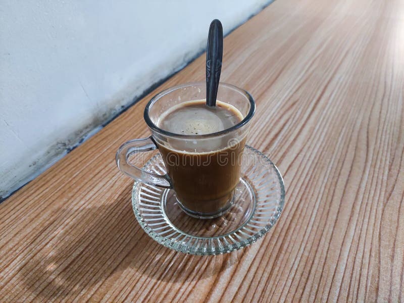 The Coffee Milk is Stirred in the Glass Using a Spoon Stock Photo ...