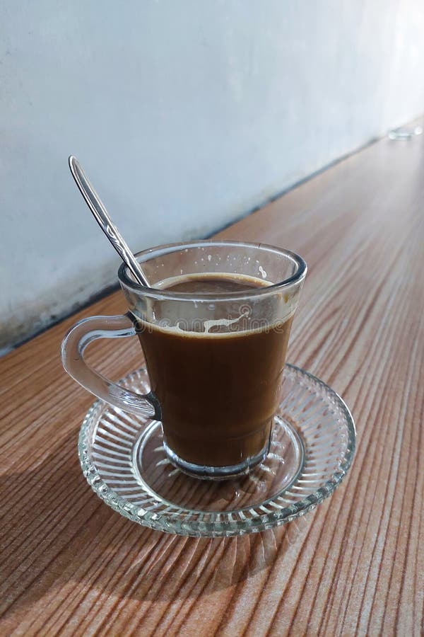 The Coffee Milk is Stirred in the Glass Using a Spoon Stock Image ...