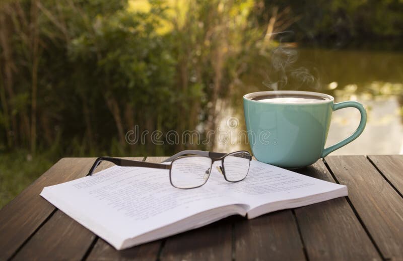 Coffee Mug with Open Book and Reading Glasses by the Water Stock Image ...