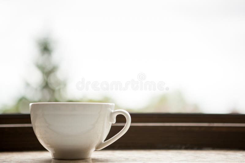 Coffee mug on a window sill - Stock Image - Everypixel