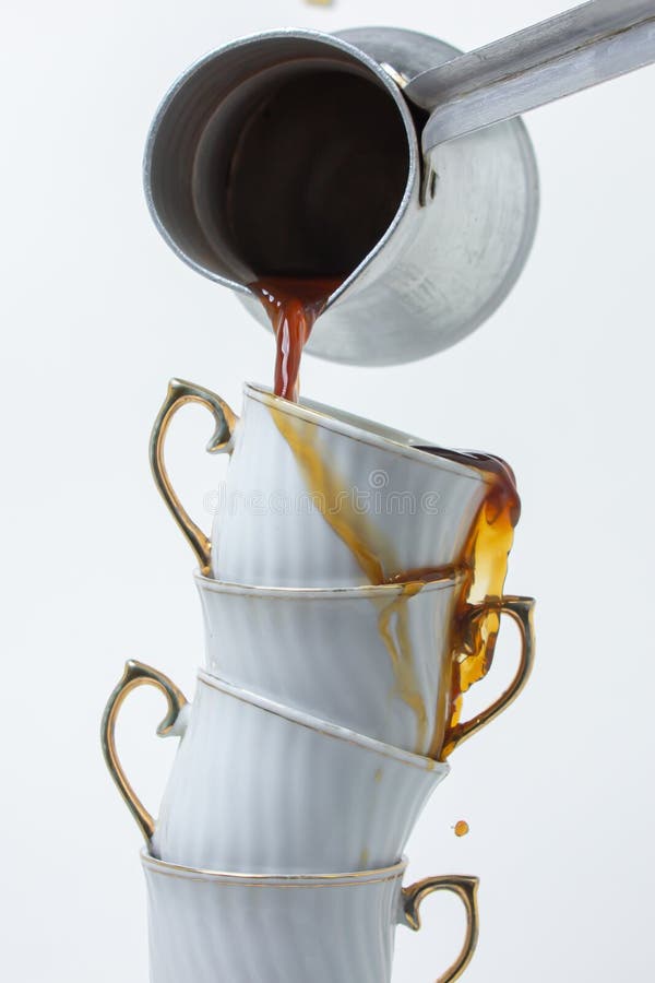 Coffee is Poured into a Coffee Cup. Coffee is Poured from a Turk Stock ...